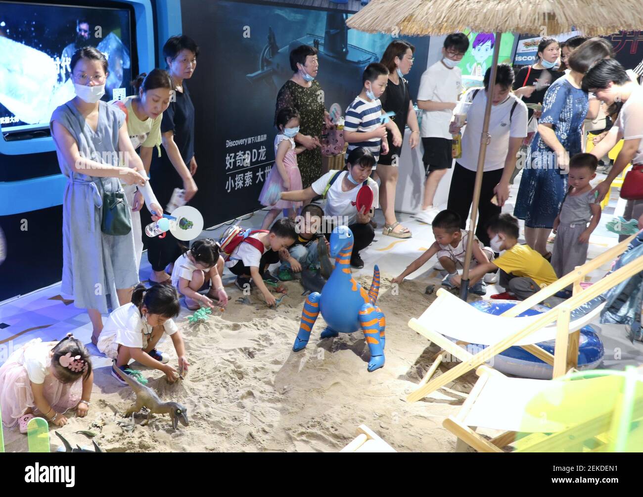 People walk around and shop at the "2020 Amazing Night in Hangzhou", a ...