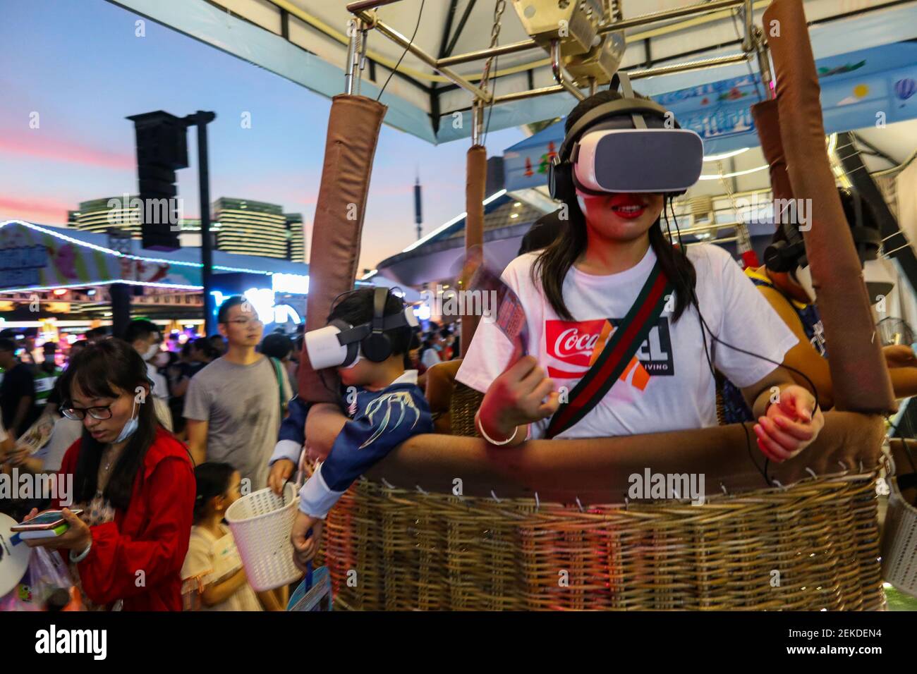People walk around and shop at the "2020 Amazing Night in Hangzhou", a ...