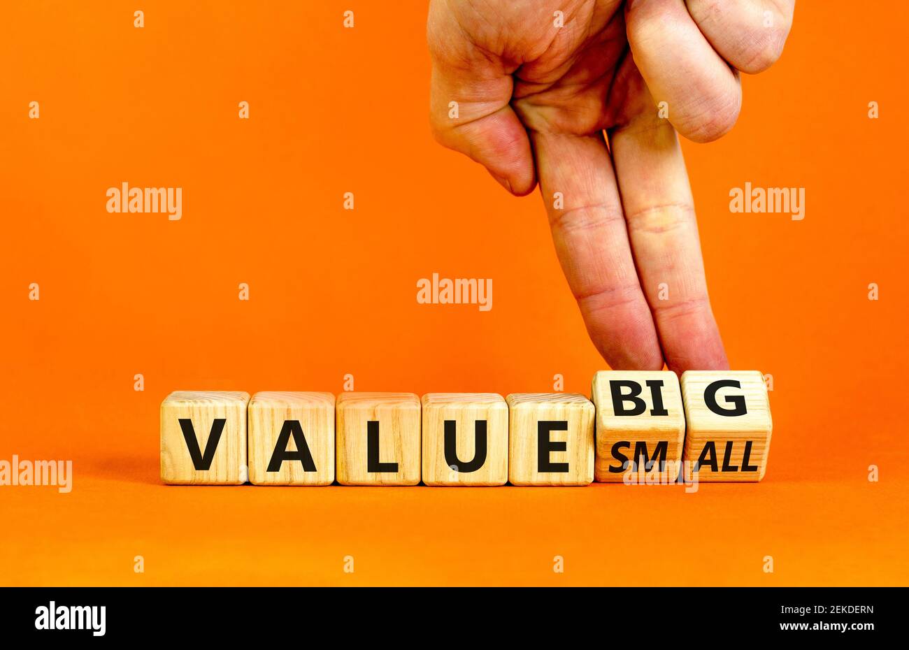 Small or big value symbol. Businessman turns wooden cubes and changes ...
