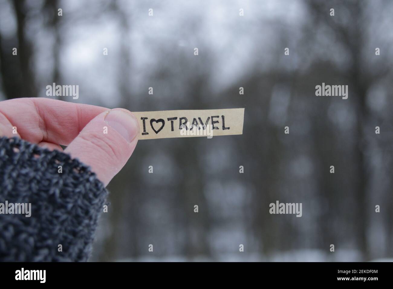 I like to travel concept. A hand holds a sign with the inscription on ...