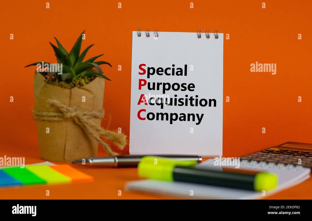 SPAC, special purpose acquisition company symbol. White note with words ...