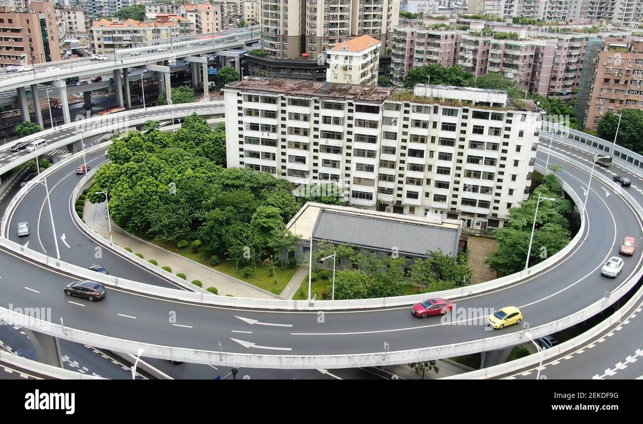 View of a nail house surrounded by elevated highway in Guangzhou city ...