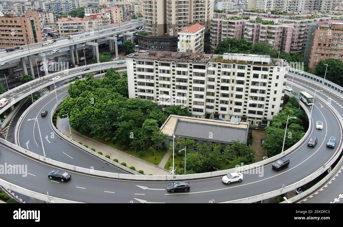 View of a nail house surrounded by elevated highway in Guangzhou city ...