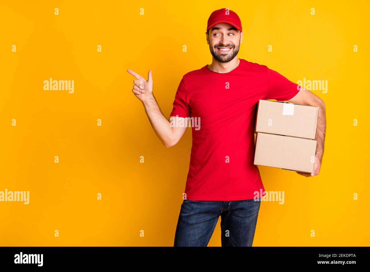 Photo of funny delivery man wear red outfit holding brown box looking ...