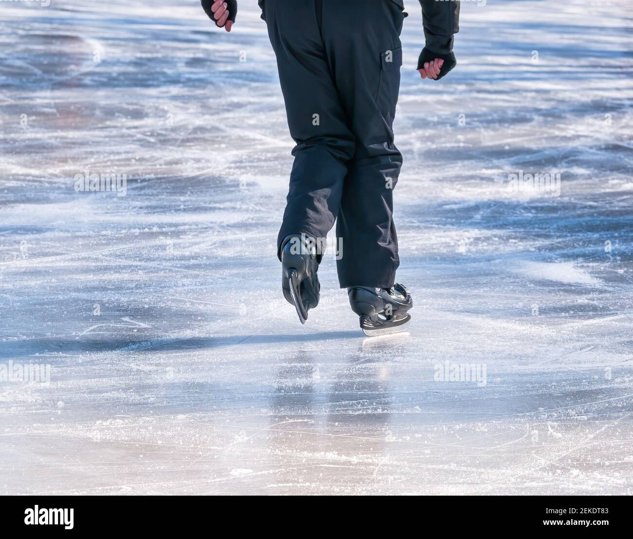 Close up with a man or a woman with skates on ice. Ice skating ...
