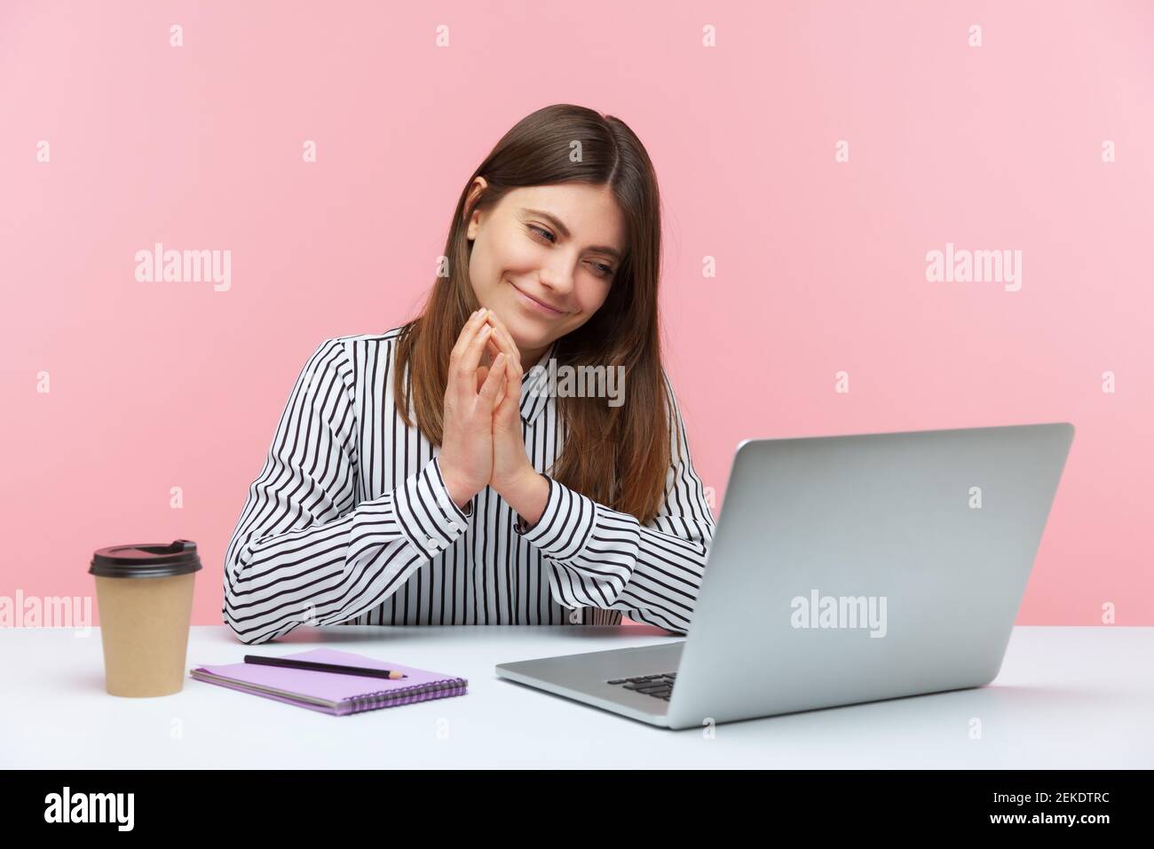 Cunning brunette woman office worker scheming and conspiring with ...