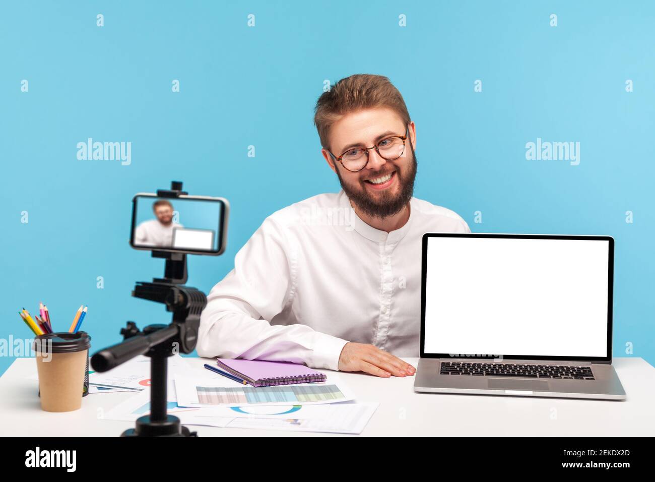Positive smiling man office worker demonstrating laptop with white ...