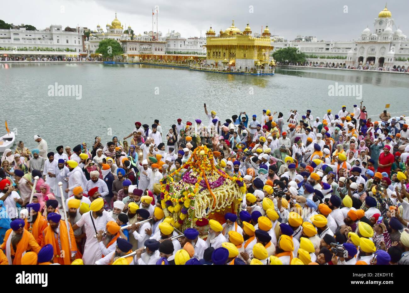 AMRITSAR, INDIA - AUGUST 19: Devotees carry the holy book Guru Granth ...