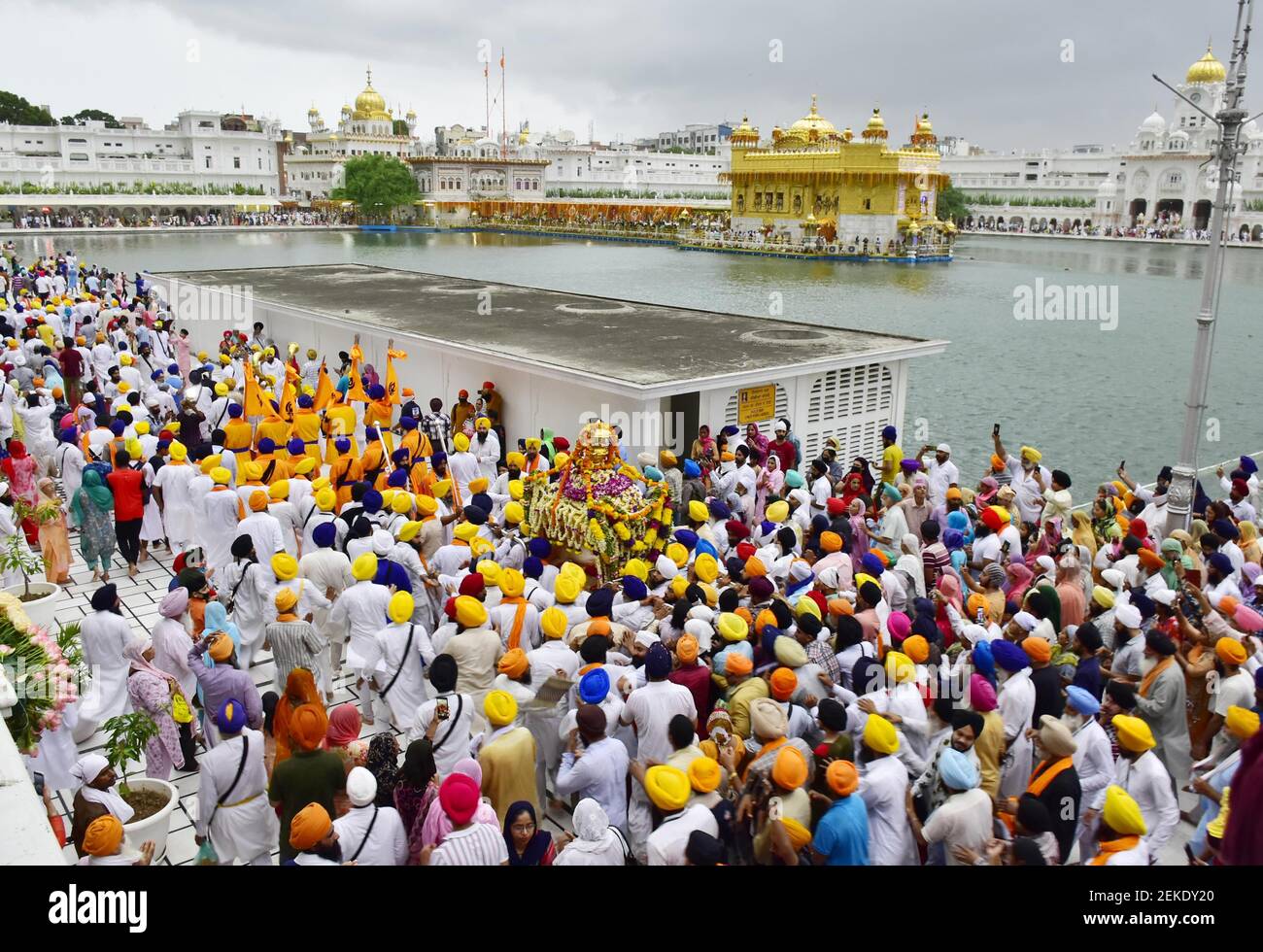 AMRITSAR, INDIA - AUGUST 19: Devotees carry the holy book Guru Granth ...