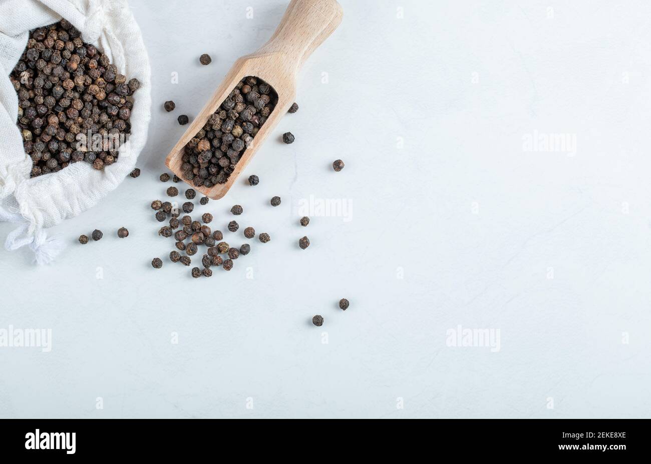 A white sack full of dried pepper on a gray background Stock Photo - Alamy