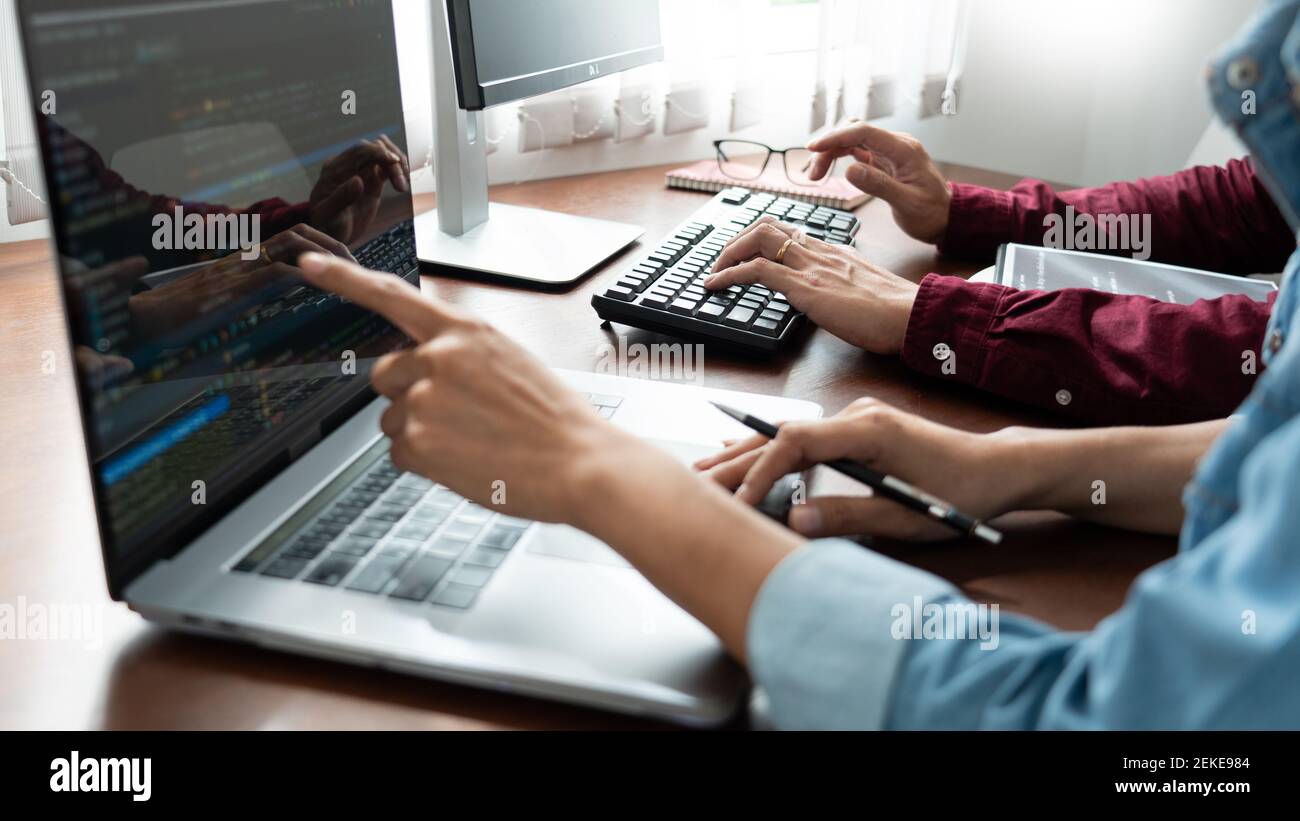 Team of Programmer working to find solution to problem and coding technologies in a software ...