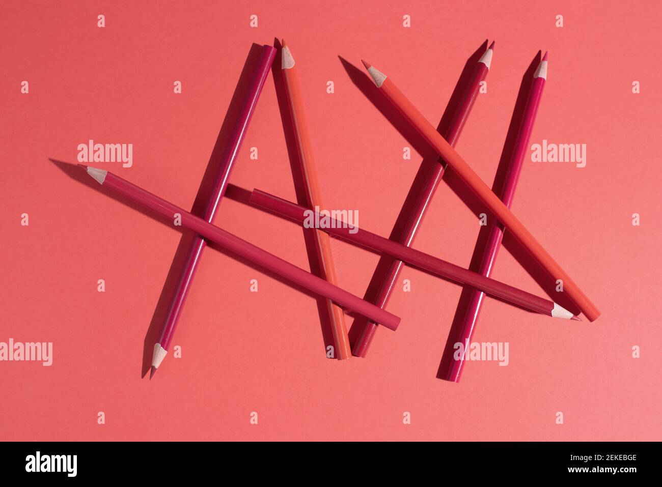 red pencils on red background in hard light Stock Photo - Alamy