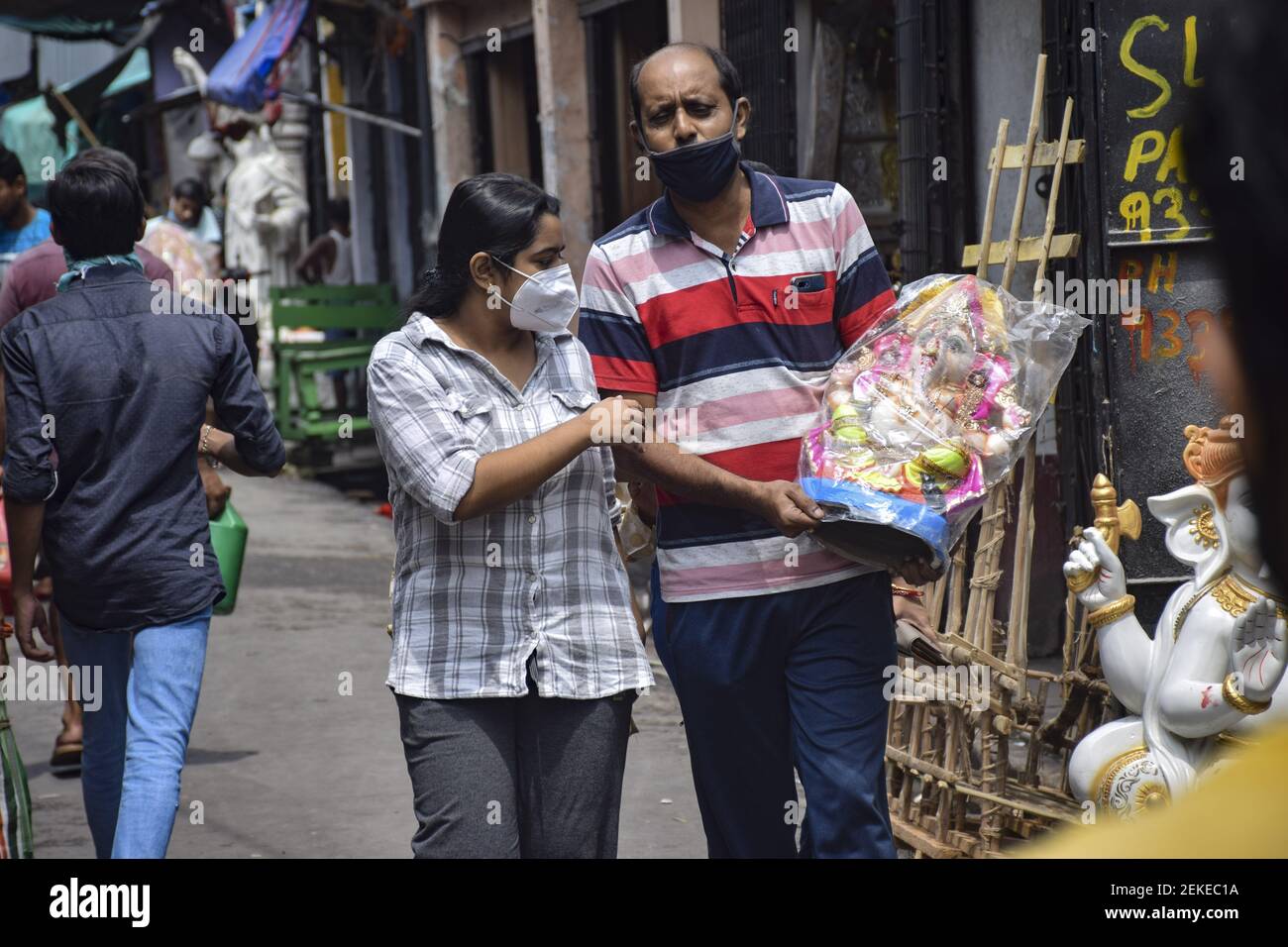 A devotee seen carrying an idol of Lord Ganesha during the festival ...