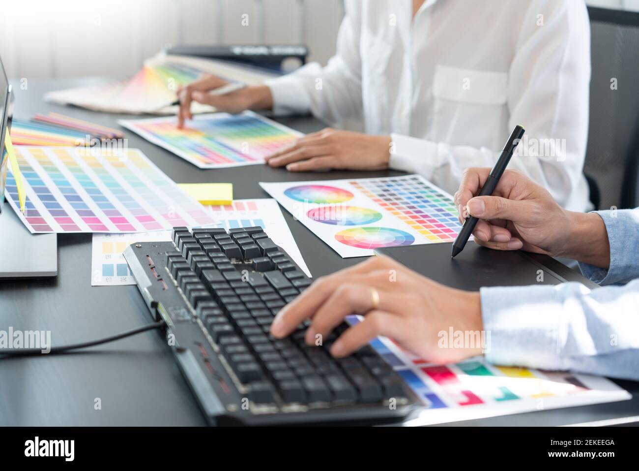 graphic designer team working on web design using color swatches ...