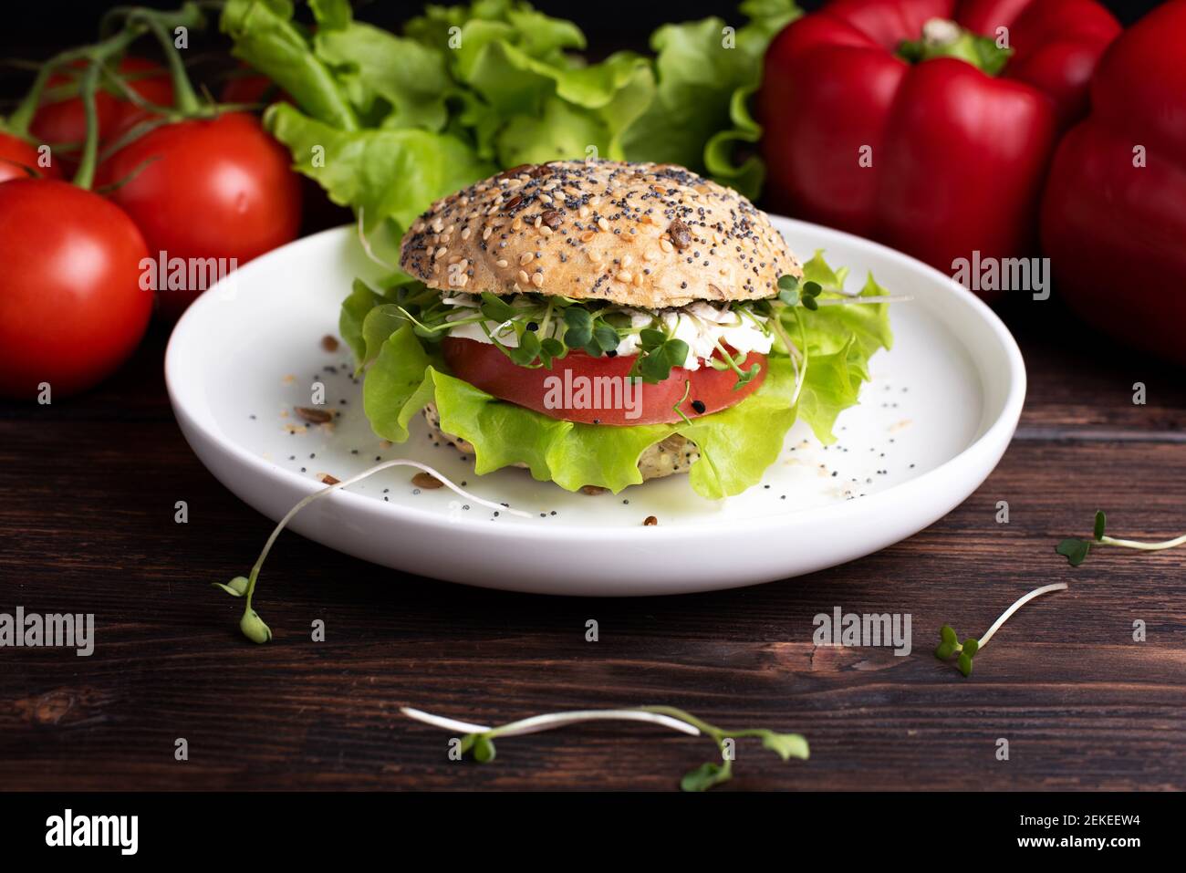 Vegetarian burger with green, red vegetables and micro grins on a white ...