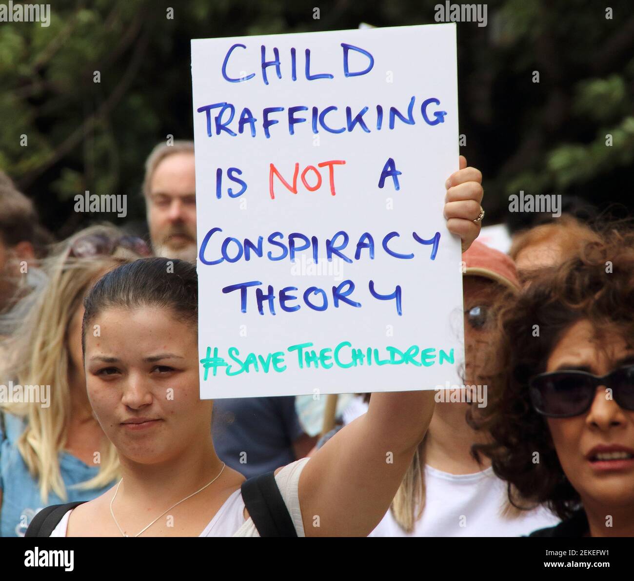 A protester holds a placard during the demonstration. Save Our Children ...
