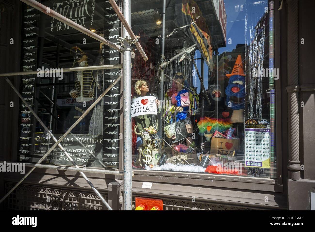 A woman looks for spot in a store window in New York to place her â ...