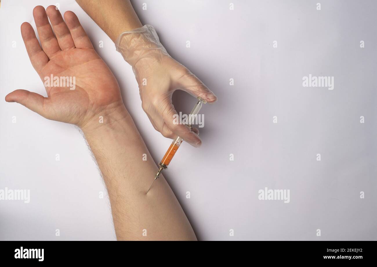 The doctor makes an injection in the hand of a person Stock Photo - Alamy
