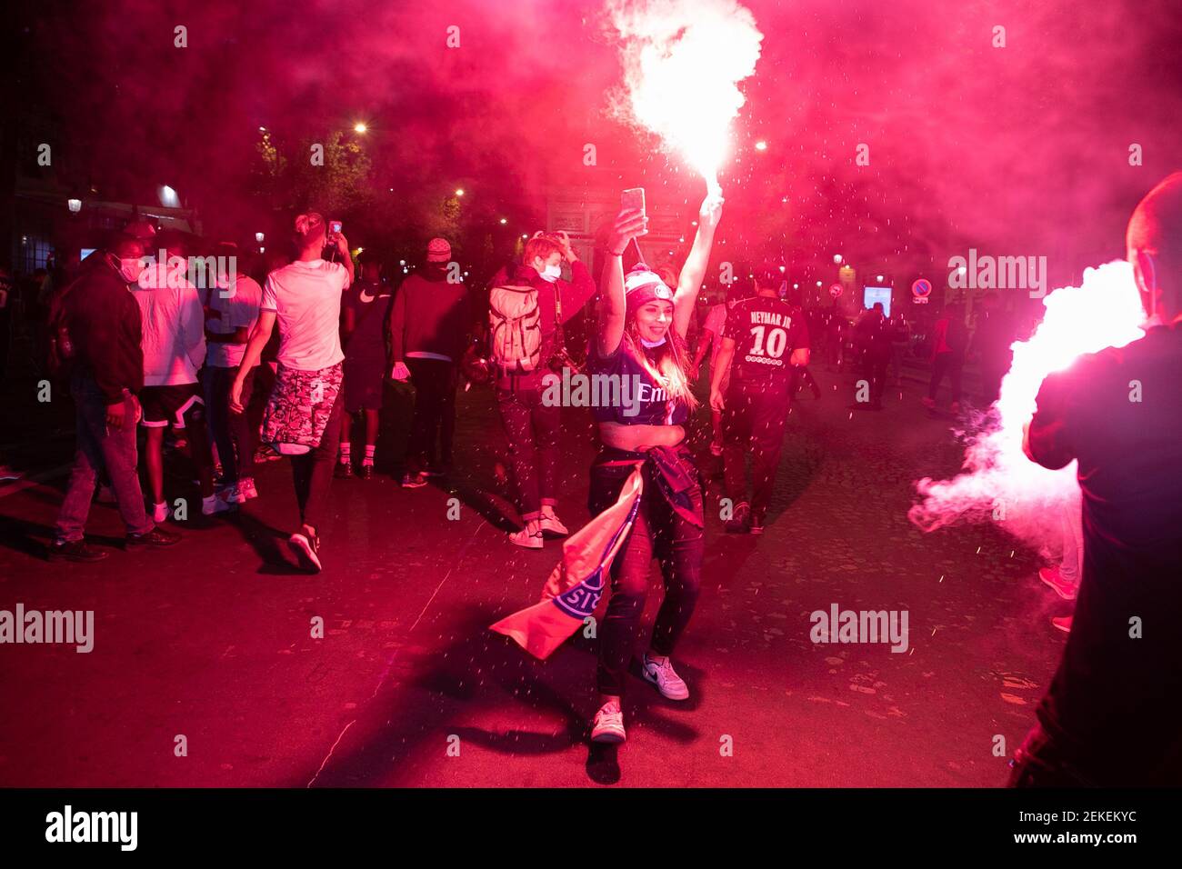 PSG fans hold burning flares as they celebrate their team's performance ...