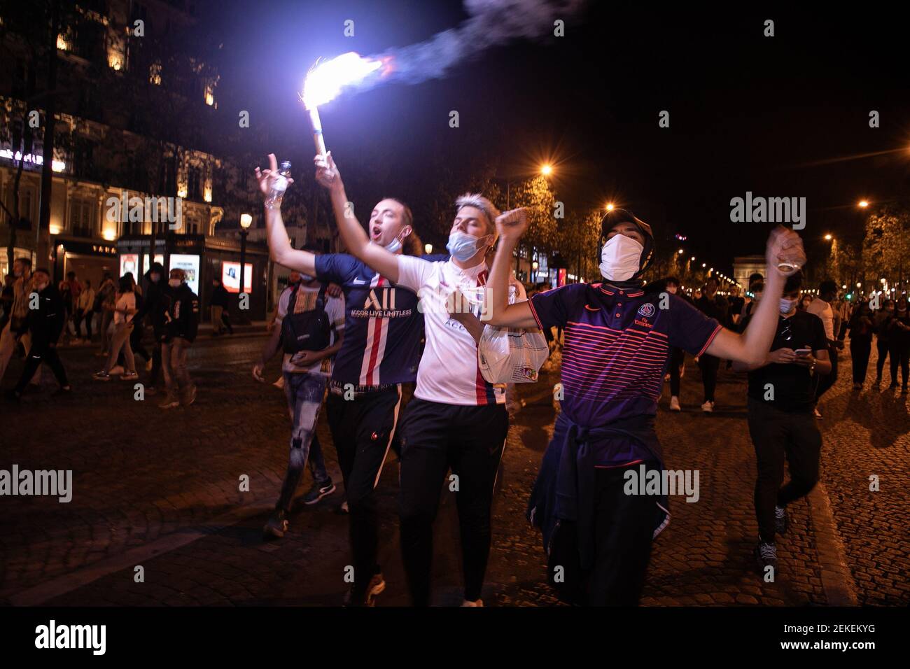 PSG fans hold burning flares as they celebrate their team's performance ...