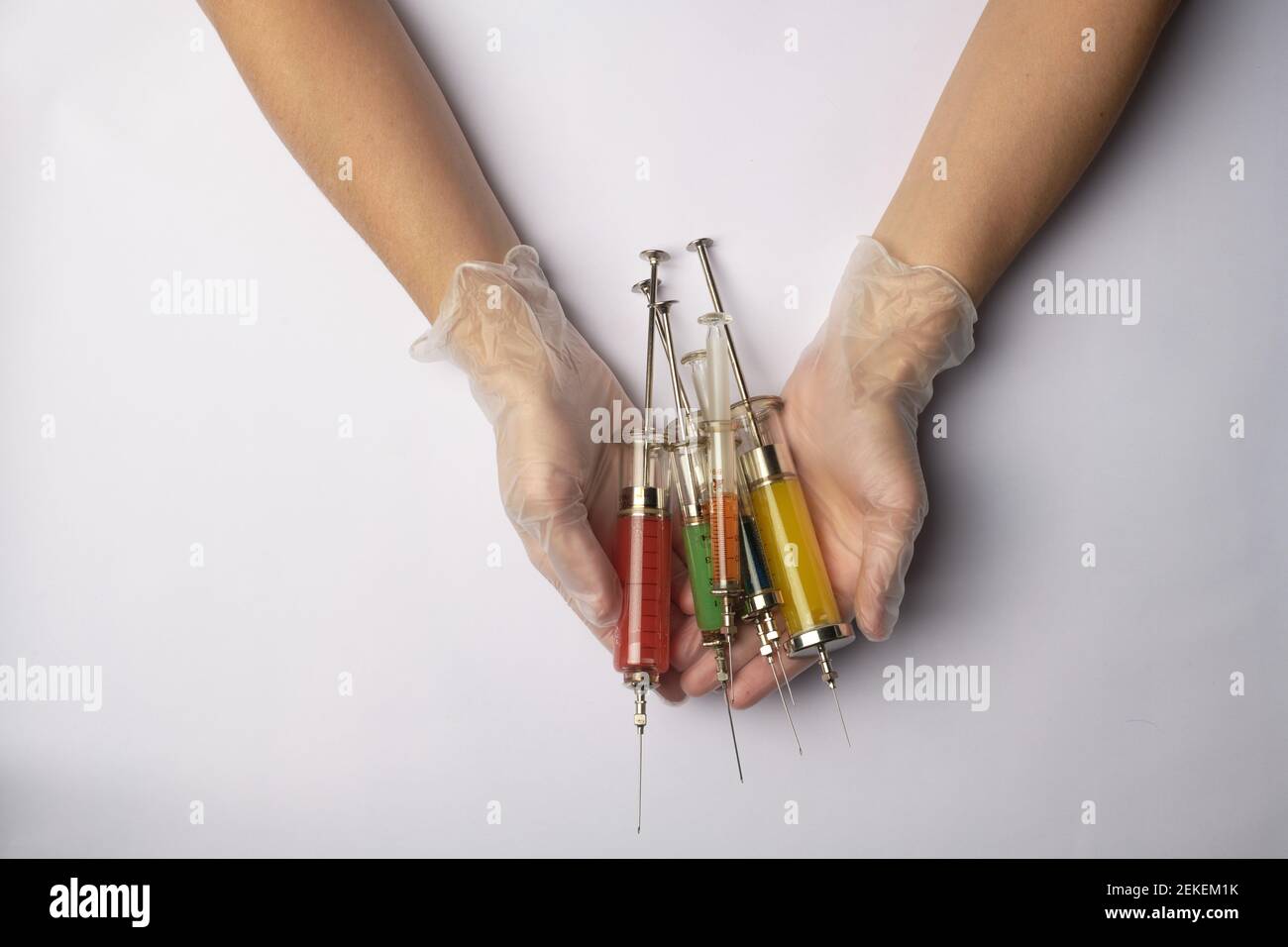 Medical worker holding a syringe with medicine Stock Photo - Alamy