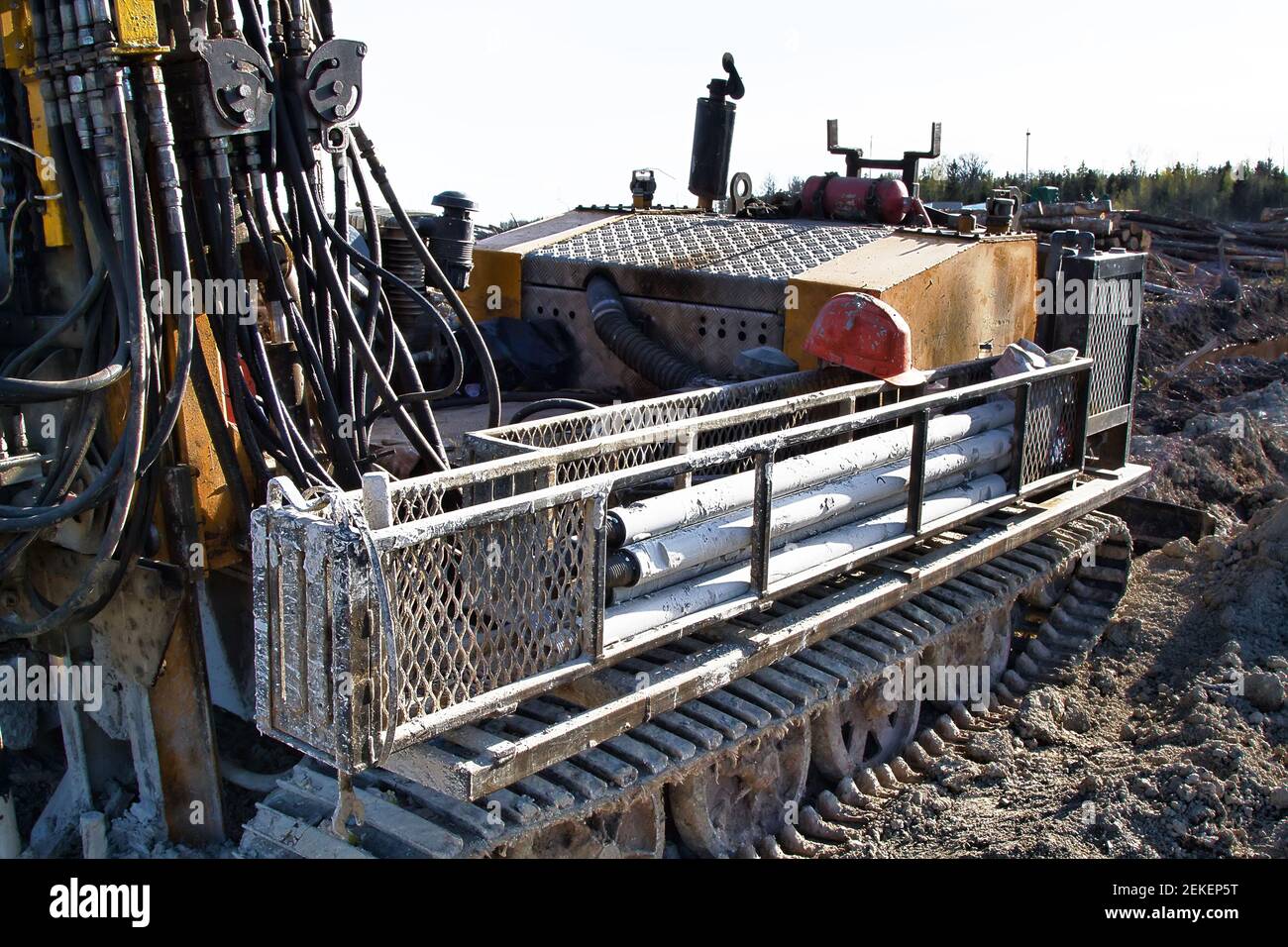 Mini-drilling rig on crawler track on site of sawn forest where large ...