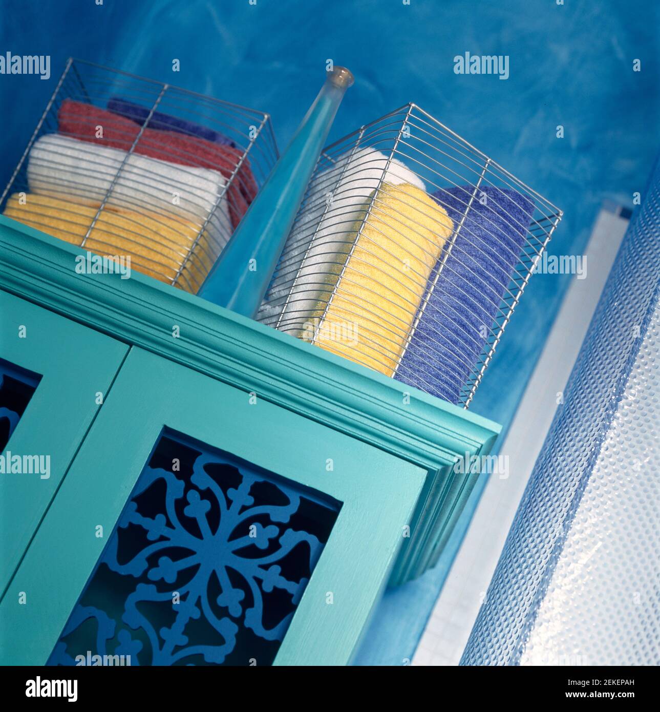 Closeup of wire boxes on top of cupboard used as storage Stock Photo ...