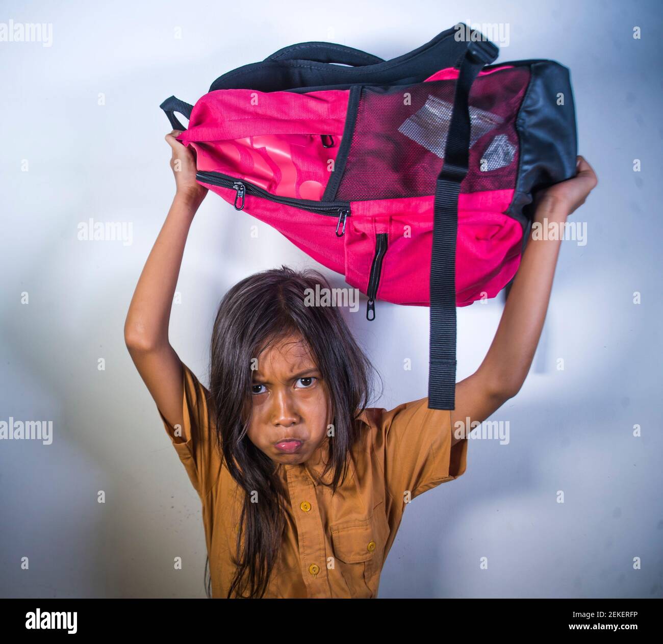 young upset and mad 7 or 8 years old female child in school uniform ...