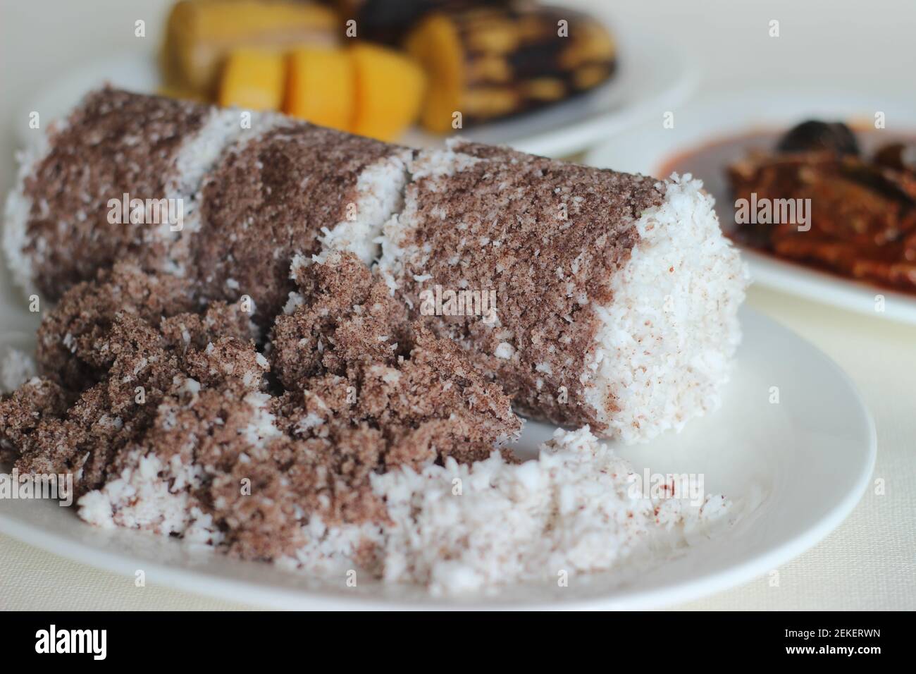 Steamed finger millet and coconut cake served with Sardines curry and ...