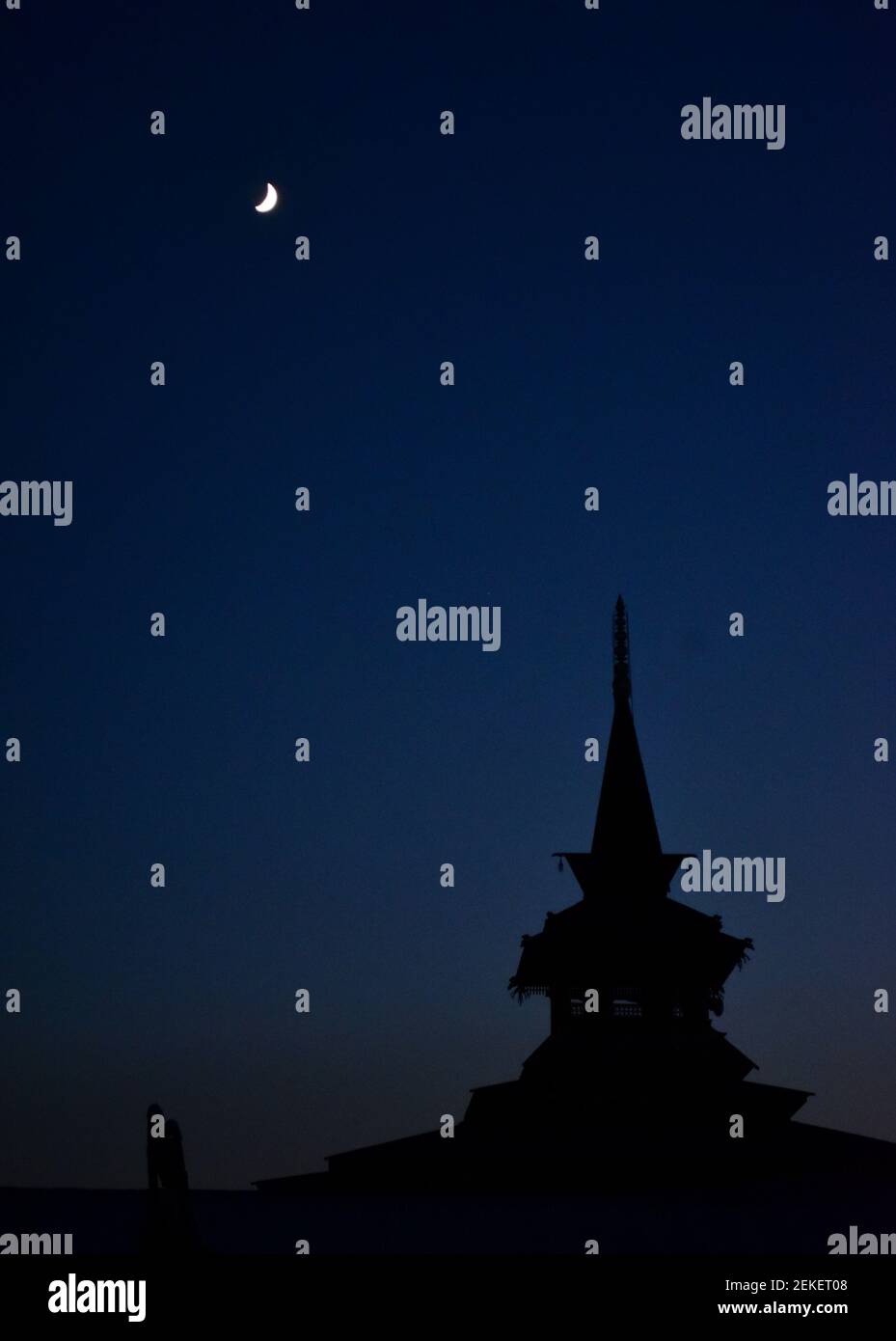 The waxing crescent moon rises over the historic Grand Mosque in ...
