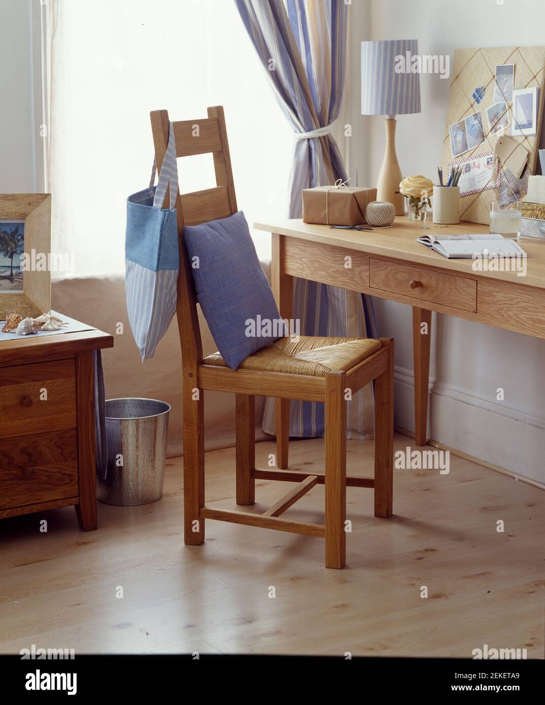 Pine table and chair used as a writing table Stock Photo - Alamy