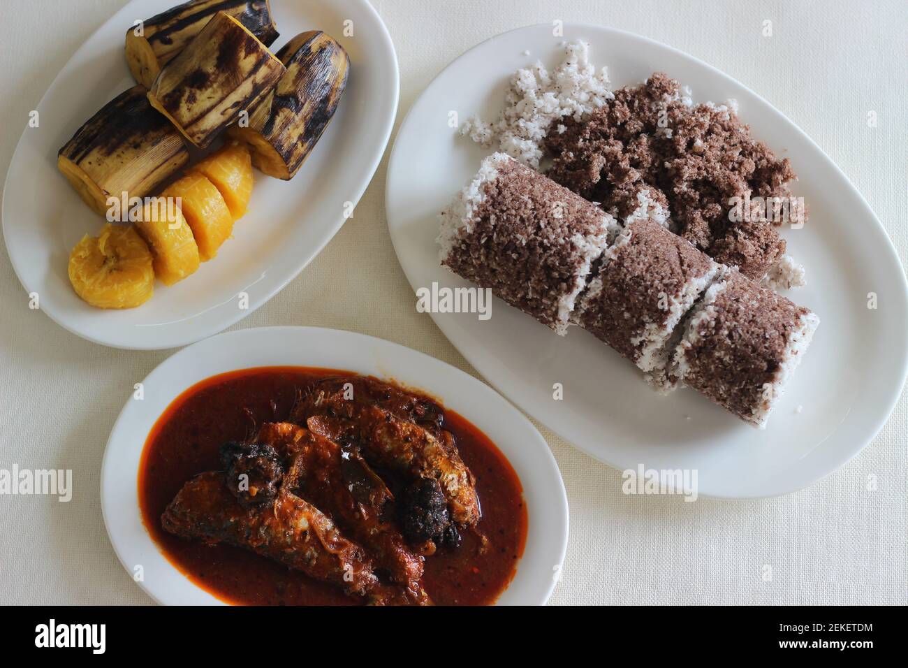 Steamed finger millet and coconut cake served with Sardines curry and ...
