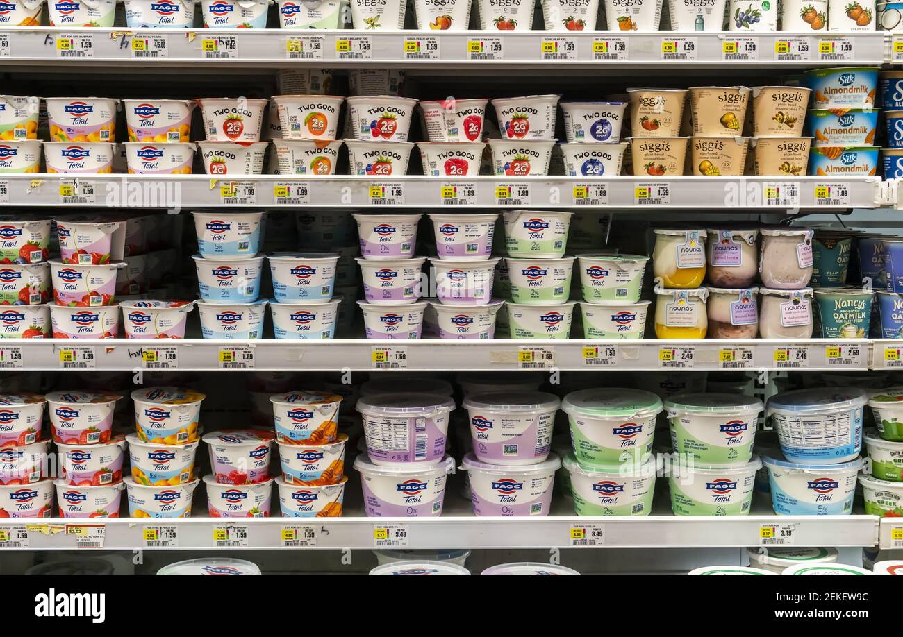 Containers of various brands of yogurt in a supermarket cooler in New ...