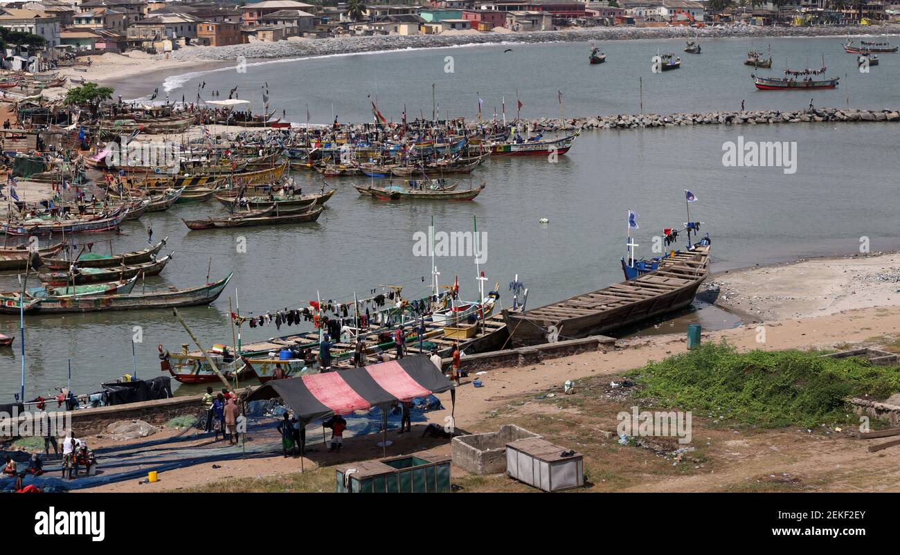 Cape Coast Ghana fishing village Africa. Old handmade fishing boats ...