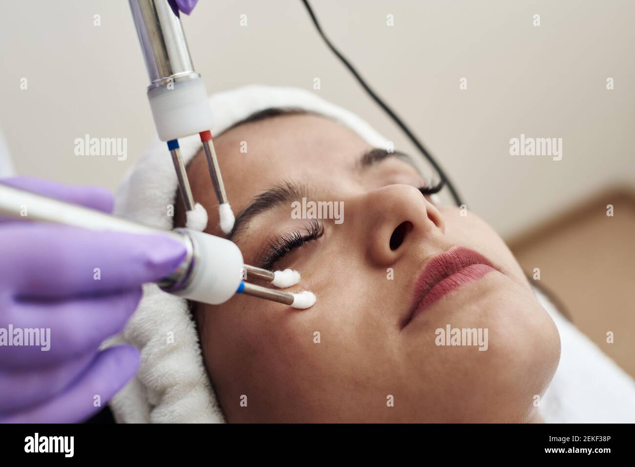Beautician using electrical impulses for healthy, firm, toned skin ...