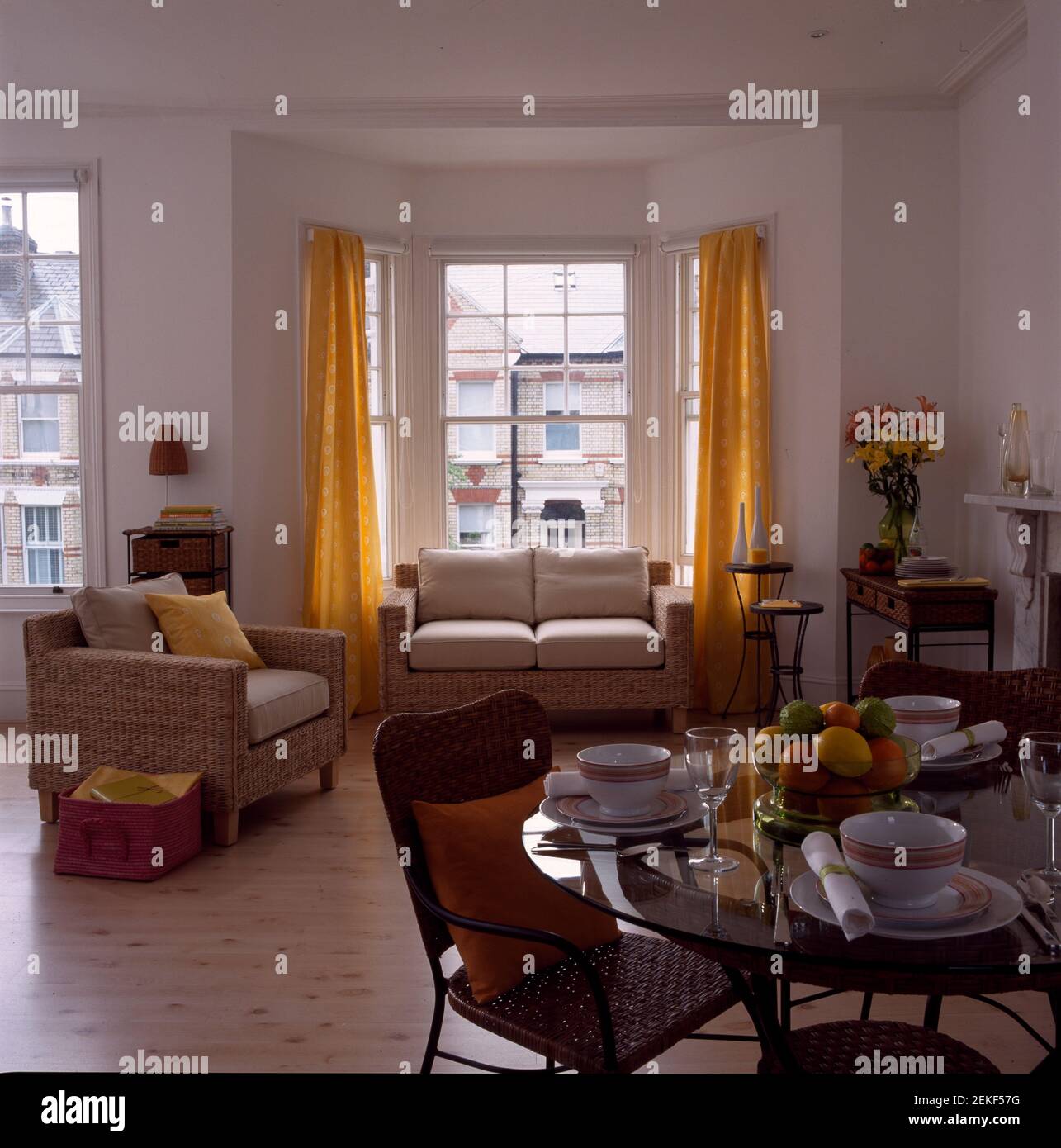 Bay window looking onto street with yellow curtains Stock Photo - Alamy