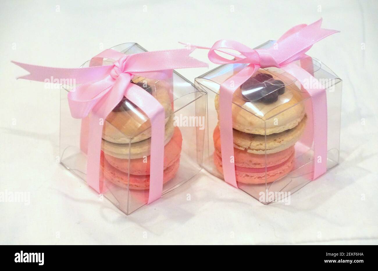 The macarons biscuits inside a see-through box as door wedding gift ...