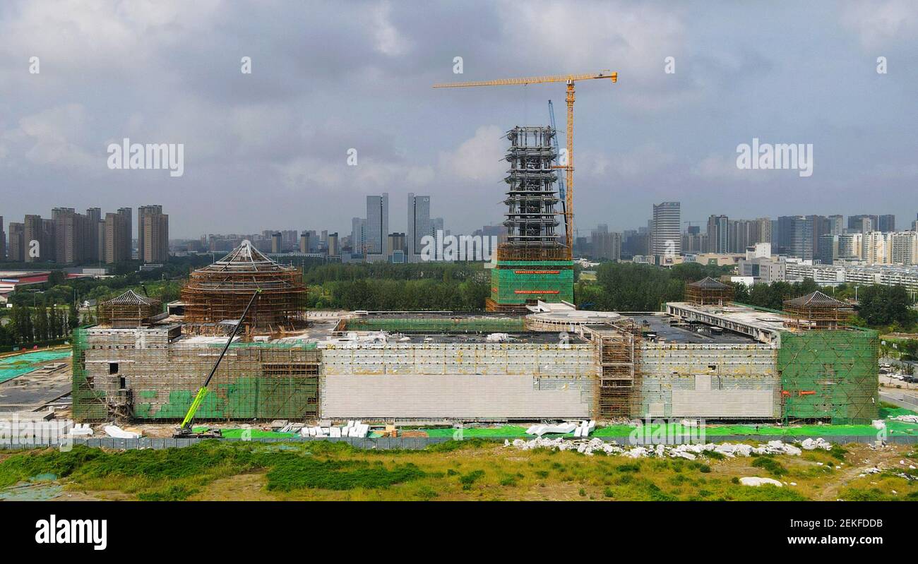 An aerial view of workers, with help of cranes and machines, building ...
