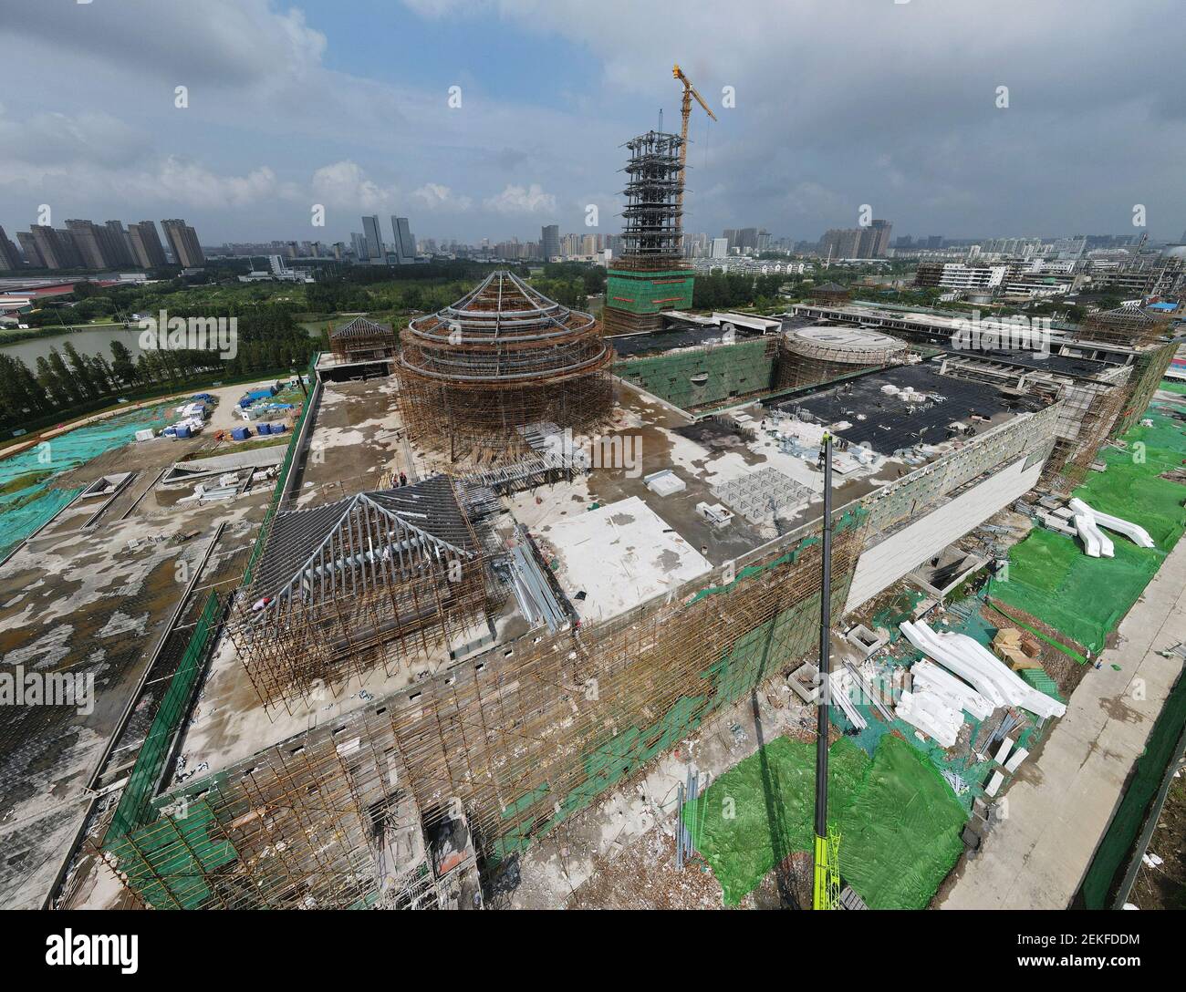 An aerial view of workers, with help of cranes and machines, building ...