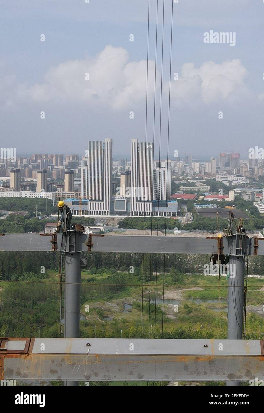 An aerial view of workers, with help of cranes and machines, building ...