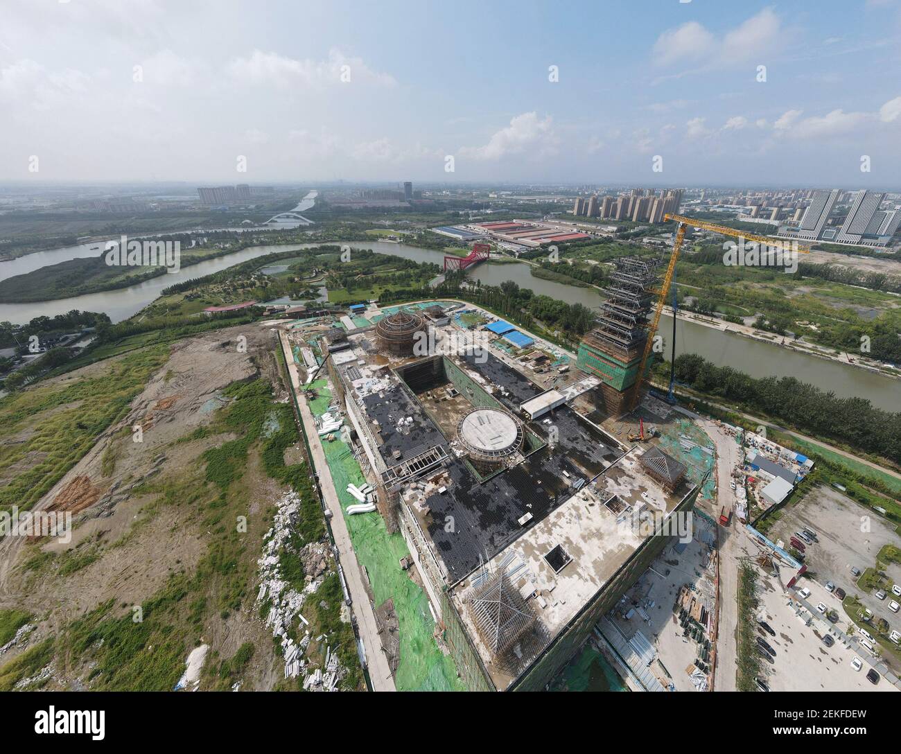 An aerial view of workers, with help of cranes and machines, building ...
