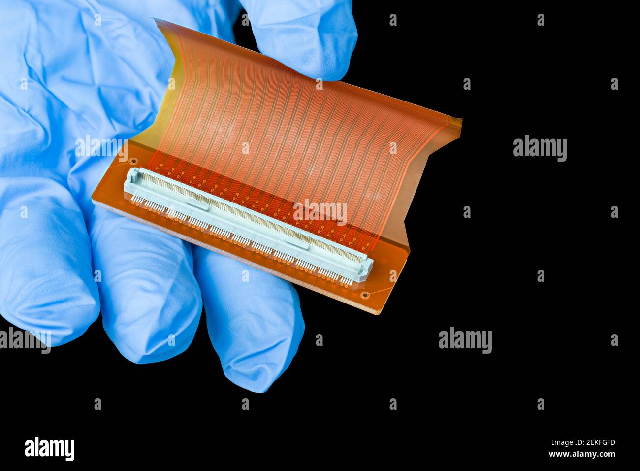 Electronic flex circuit board in technician hand isolated on black ...