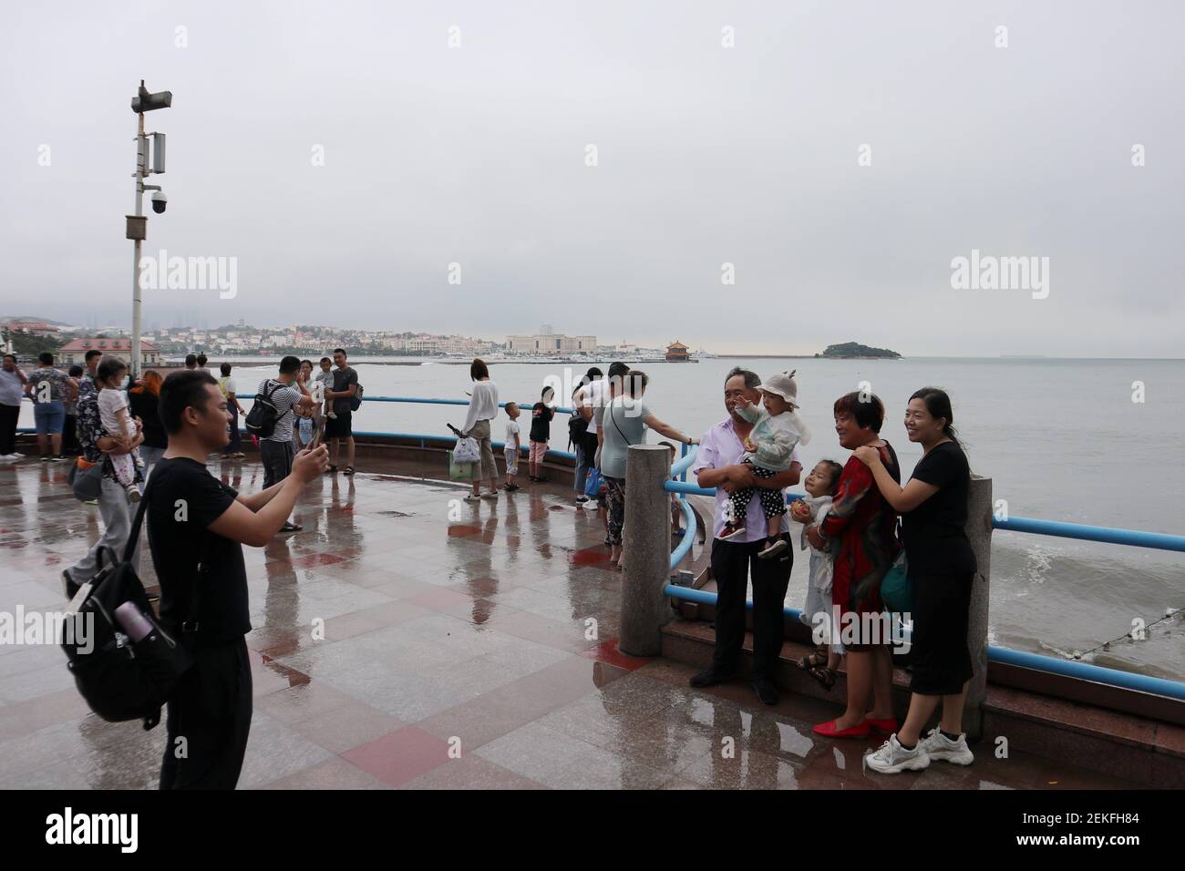 Citizens watch huge waves continuously attacking the shore as the ...