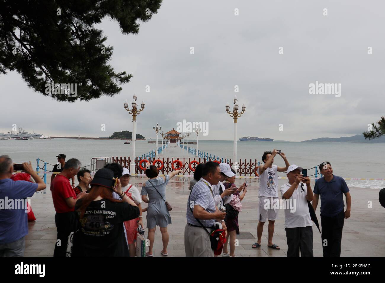 Citizens watch huge waves continuously attacking the shore as the ...