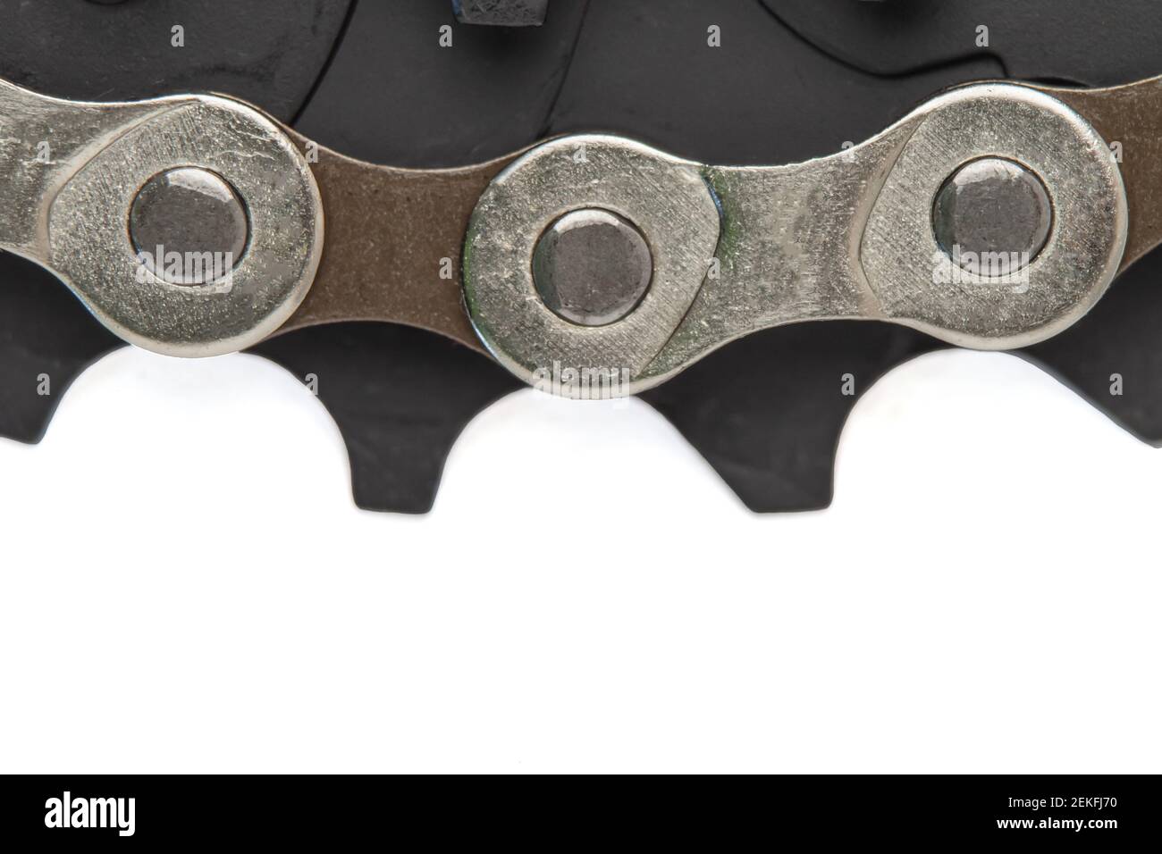 The teeth of the bicycle cassette are black and the shiny chain links ...