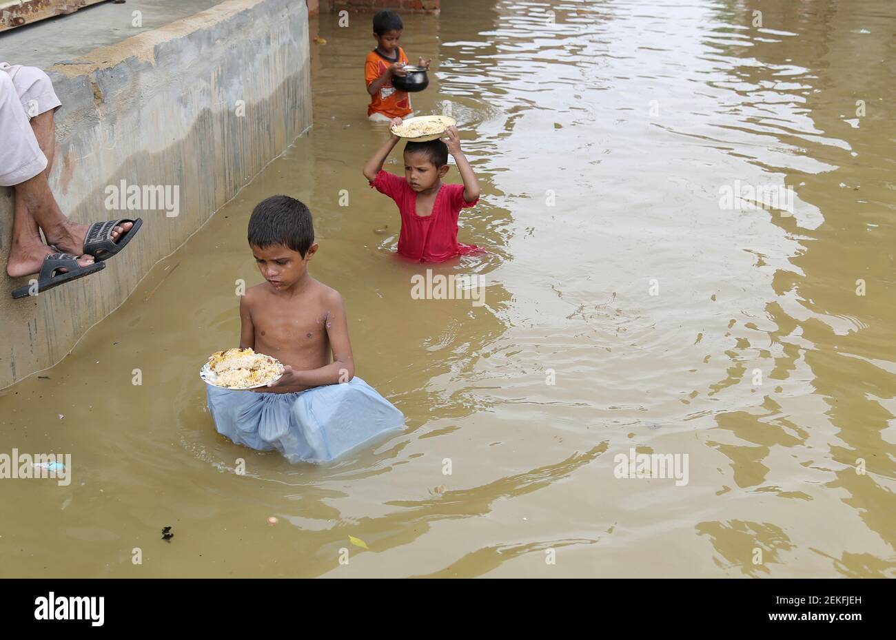 Children are carrying food and going back to there homes as they walk ...