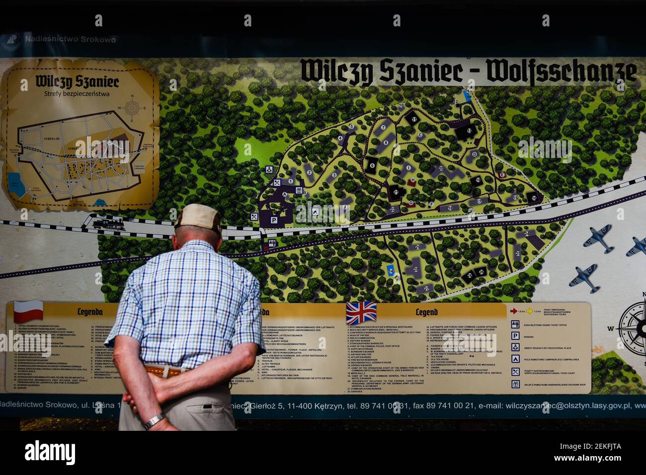 A visitor looks to a tour map before entering the historical Wolf's ...