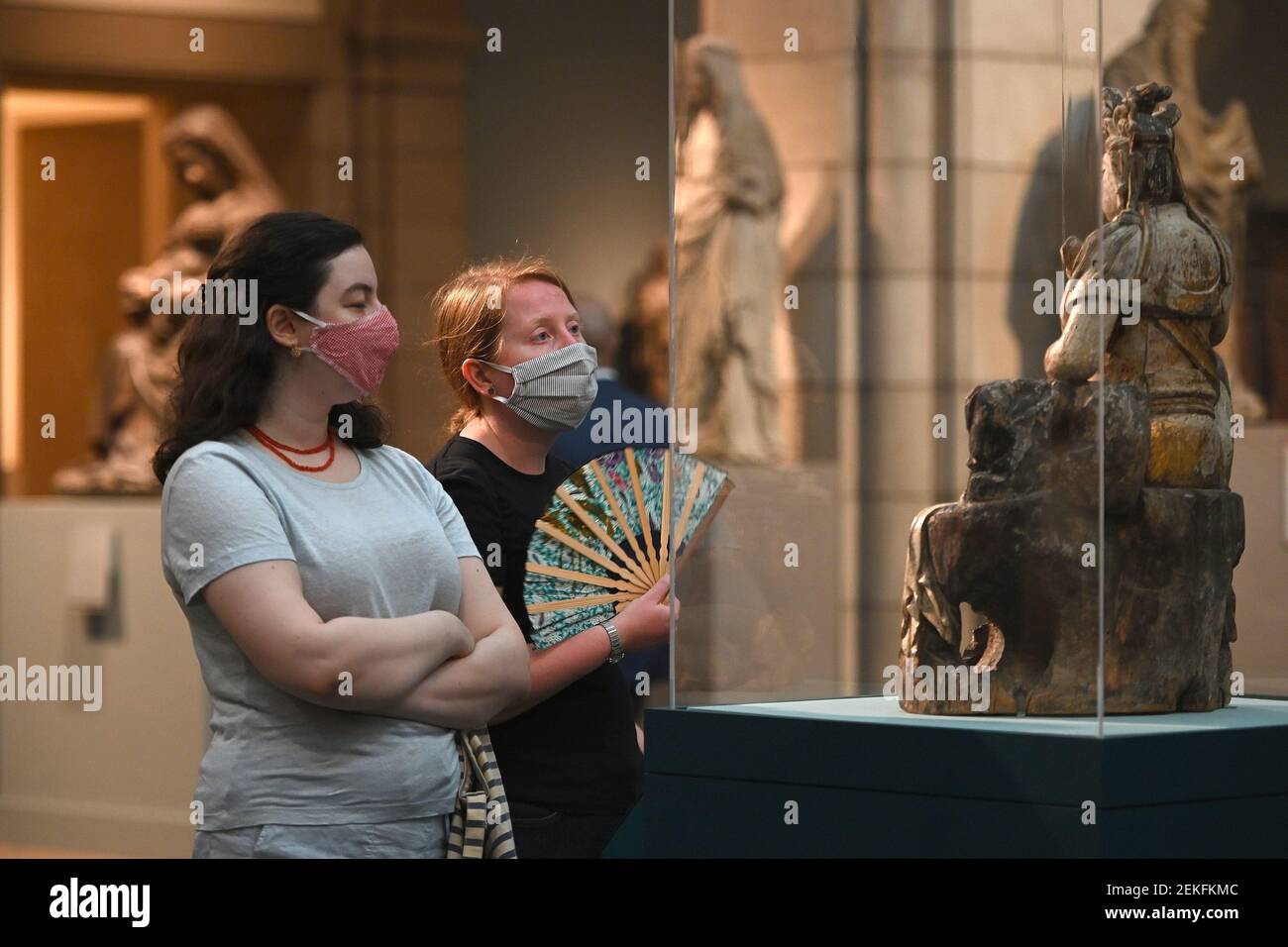 Visitors wearing masks tour The Metropolitan Museum of Art during a ...