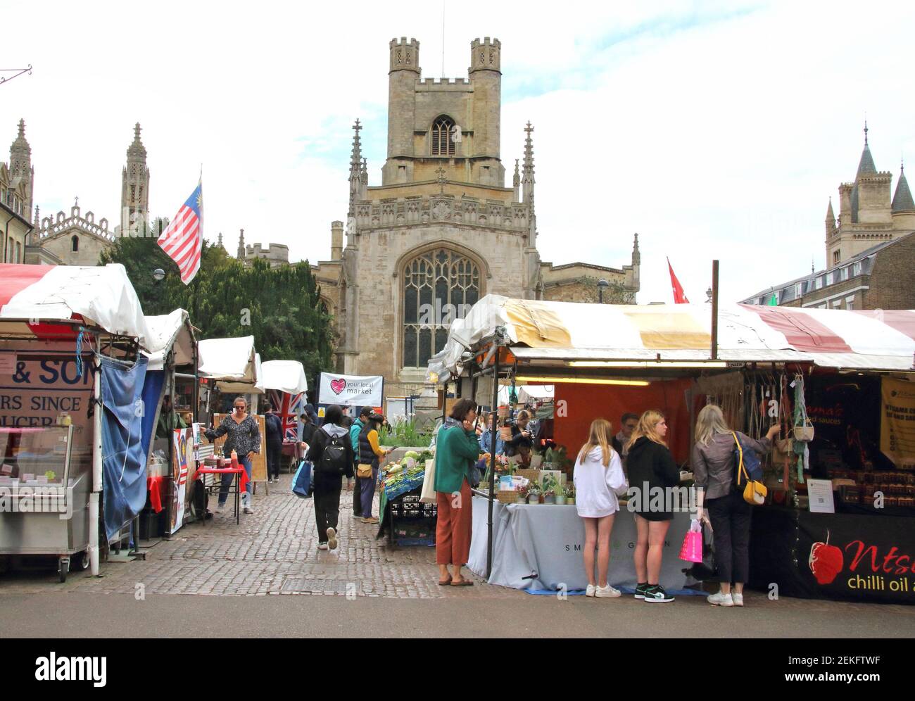 People waiting at stalls in the city center market as St Marys church ...