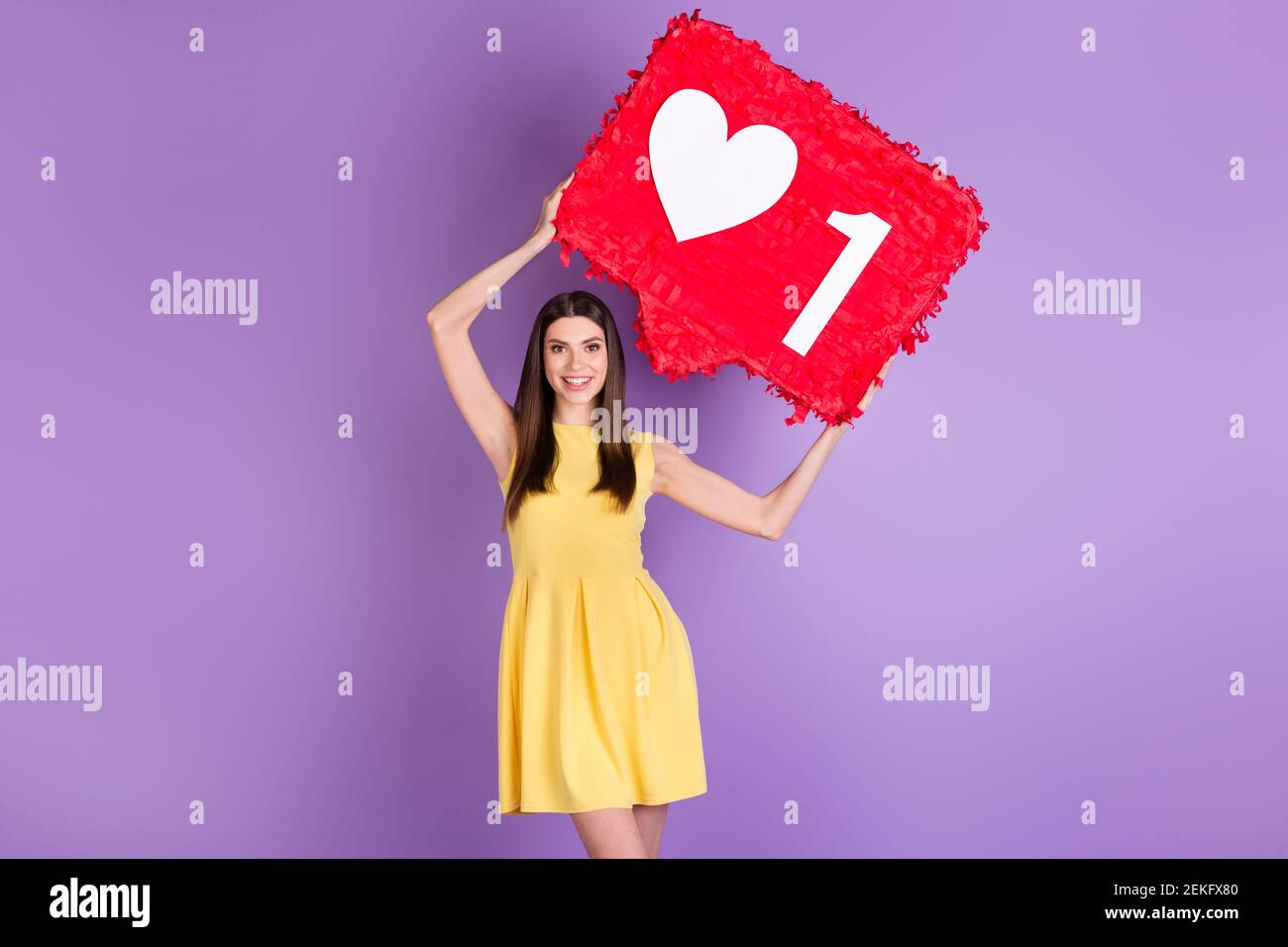 Portrait of pretty cheerful girl holding in hands big large like board ...